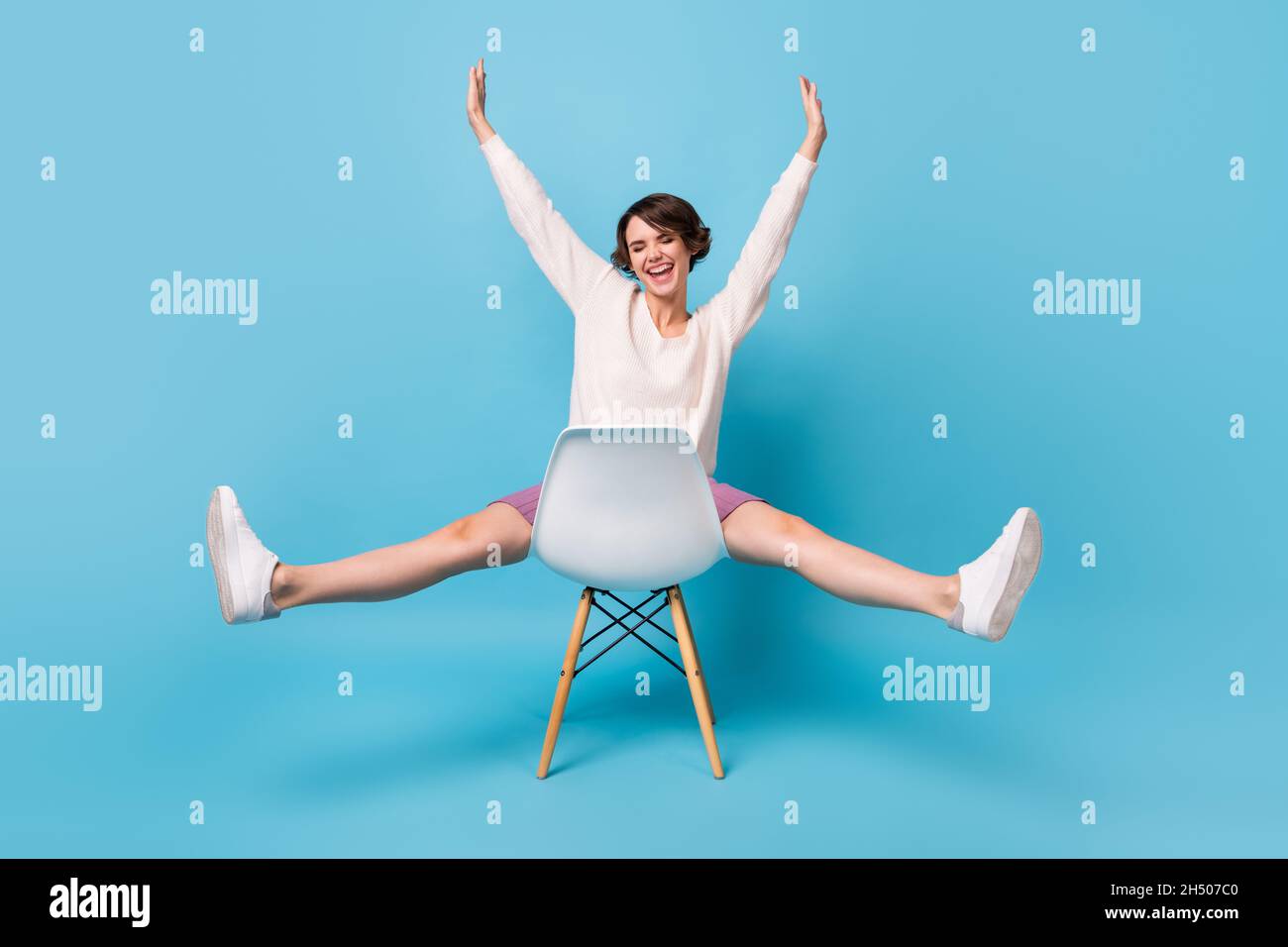 Photo portrait full body view of girl raising arms legs sitting on ...