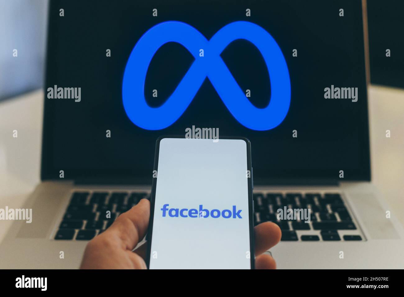 Laptop and smartphone with Meta and Facebook logo on display. New Mark ...