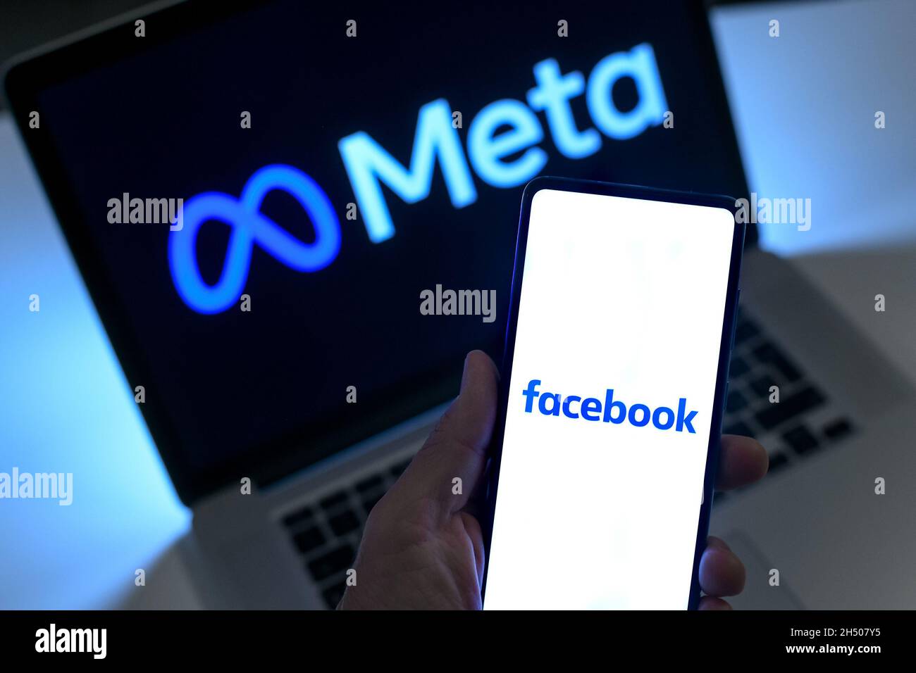 Laptop and smartphone with Meta and Facebook logo on display. New Mark ...