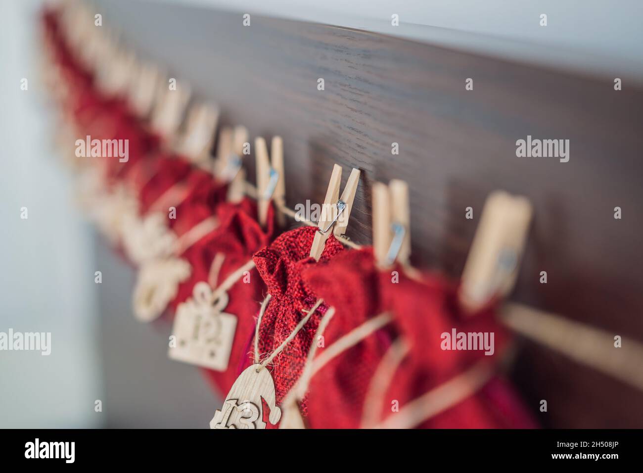 Advent calendar red bags on a rope hang on a child's bed Stock Photo ...