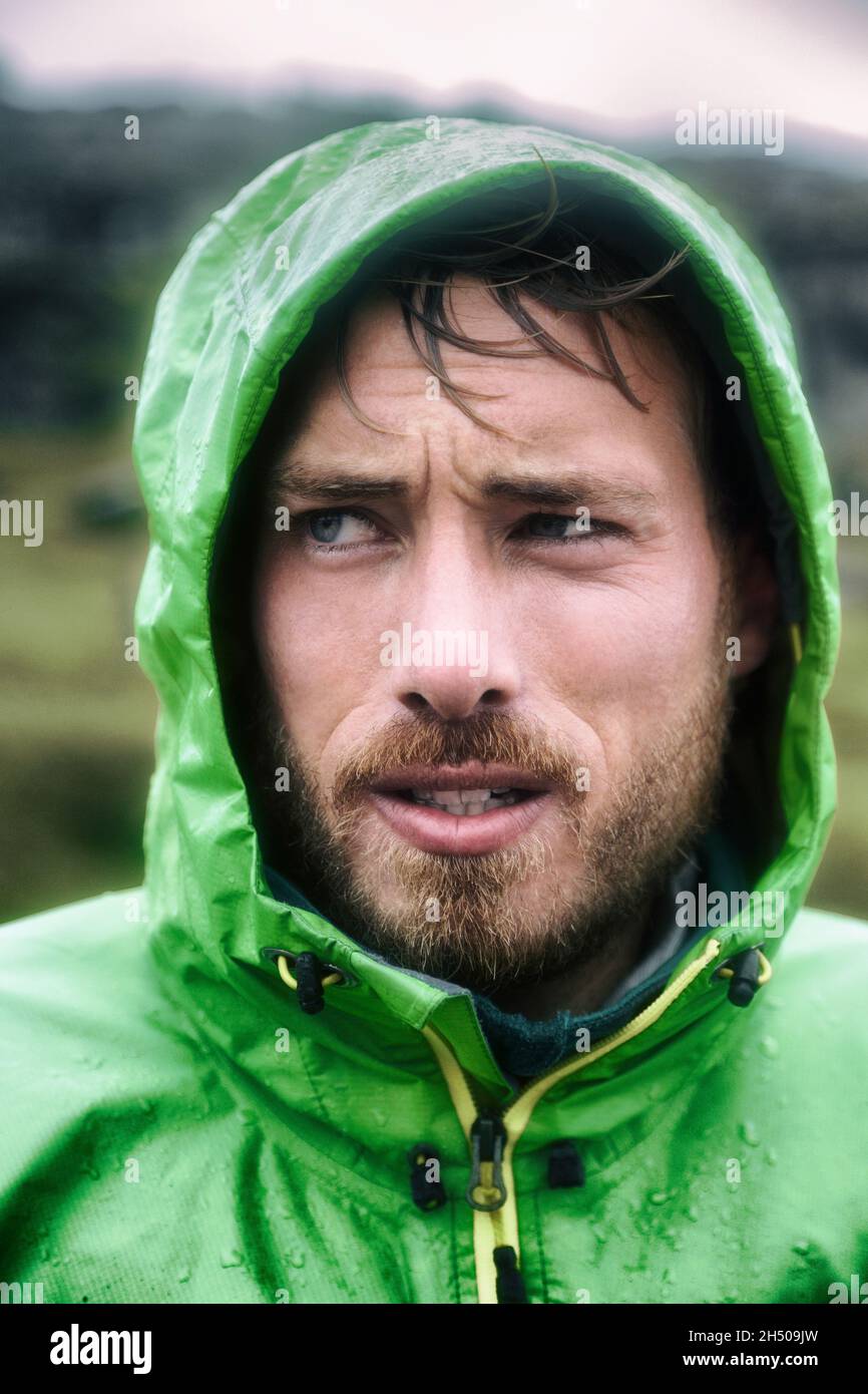 Hiker man on extreme hike adventure outdoor raining wearing waterproof ...