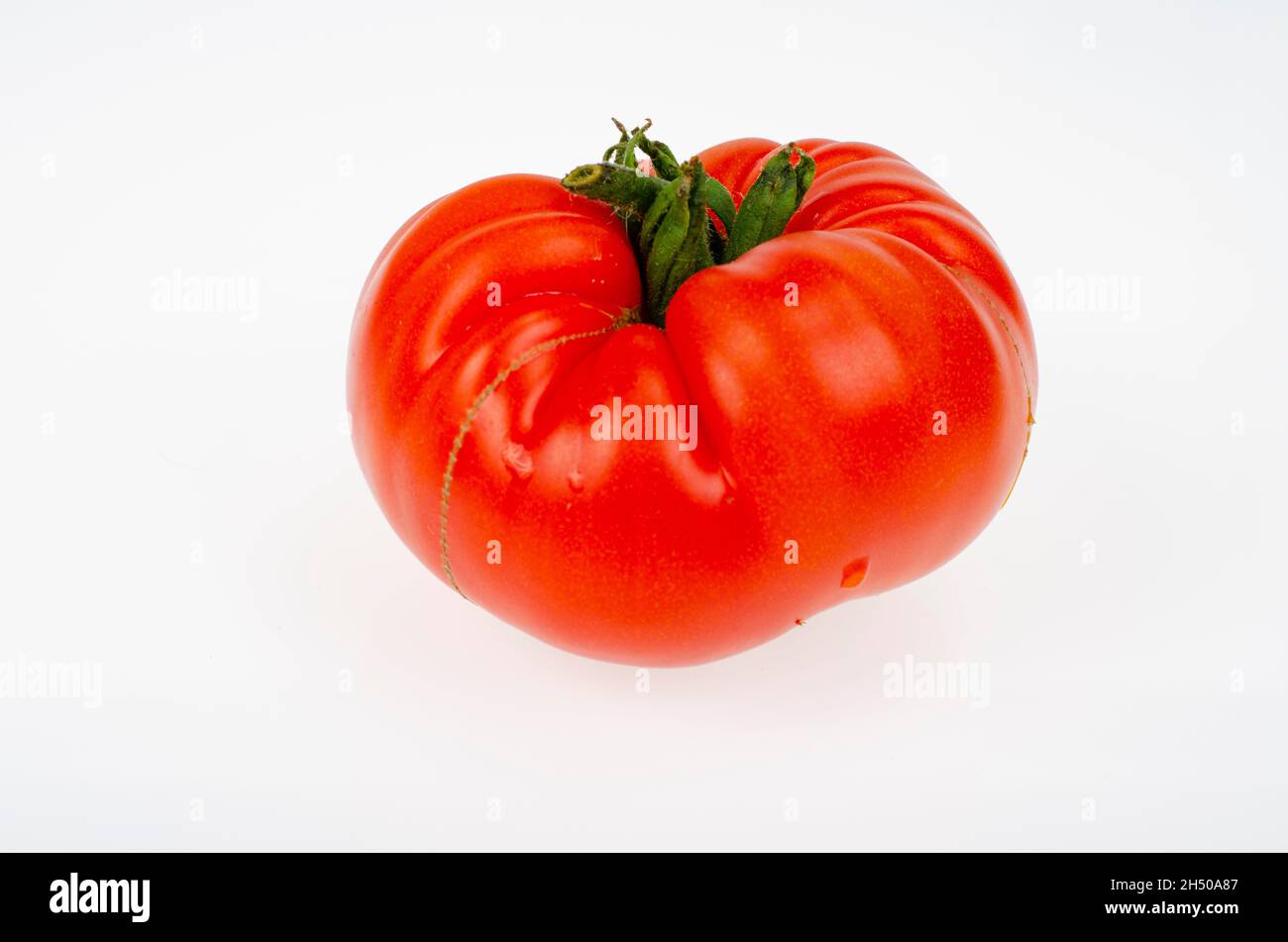 Single ripe red beef tomato isolated on white background. Studio Photo ...