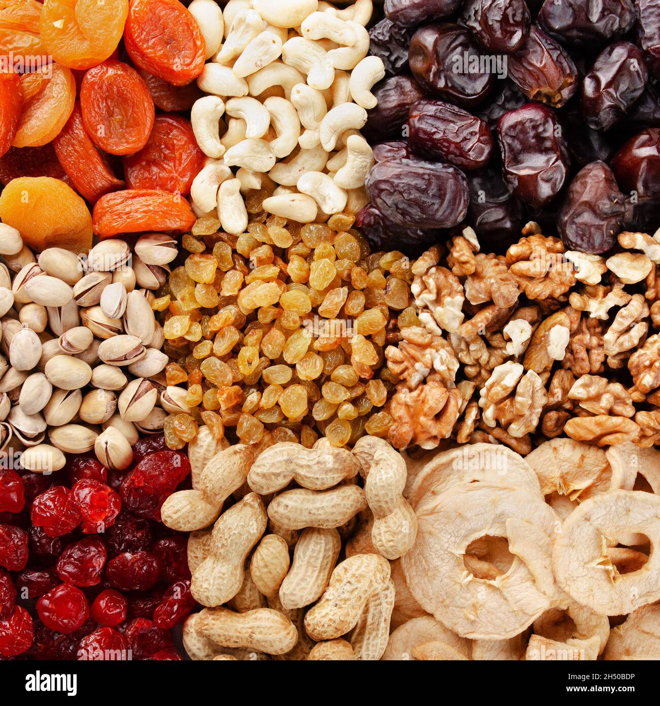 Flat lay view at assorted dried fruits and nuts. Healthy vegetarian ...
