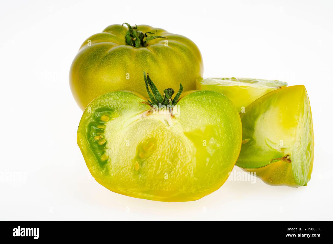 Whole fruit and slices yellow-green color of ripe tomato fruits ...