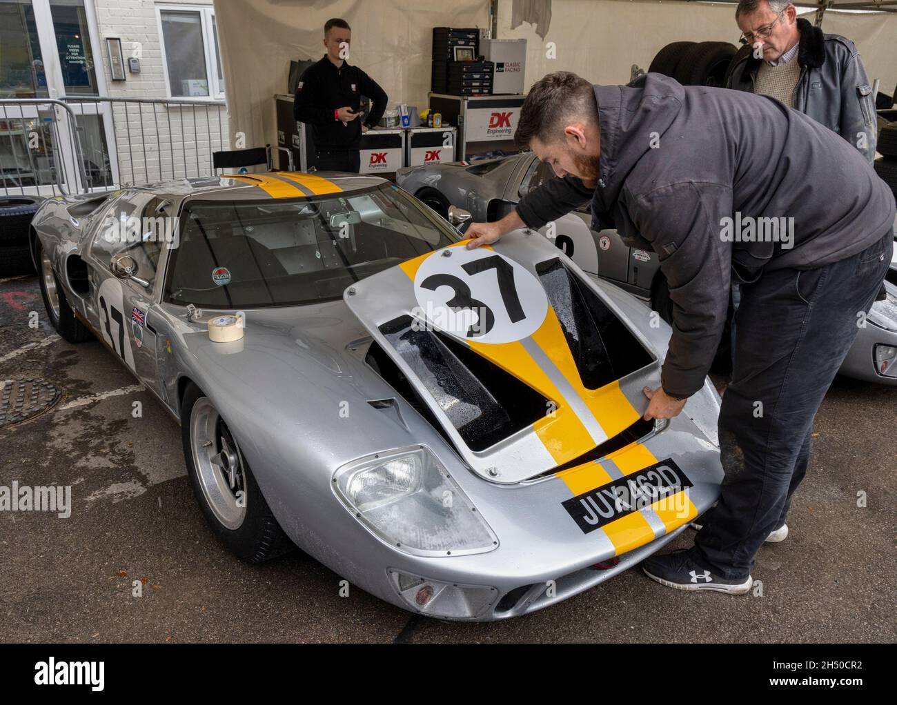 1965 Ford GT40 being prepared by a mechanic in the paddock garage ...