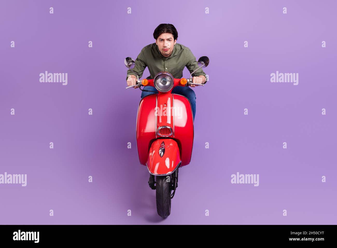 Full length photo of cool serious young man ride bike wear casual clothes isolated on violet ...