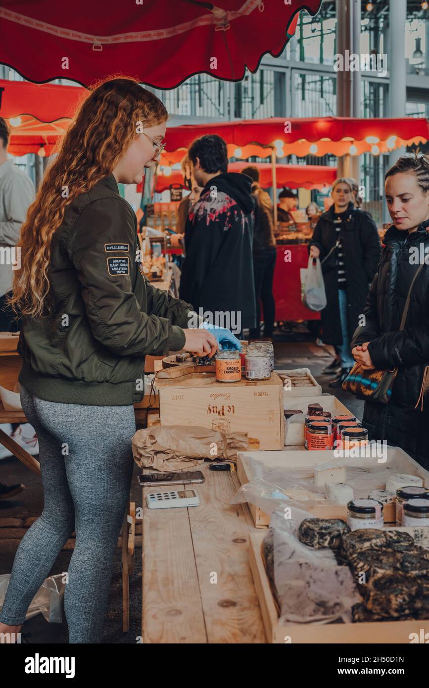 London, UK - October 17, 2021: Vendor doing a tasting at a stall inside ...