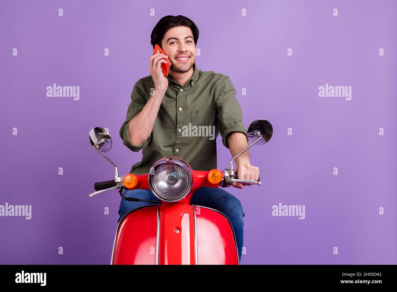 Photo of dreamy young happy man hold hand phone talk enjoy cool smile isolated on purple color ...