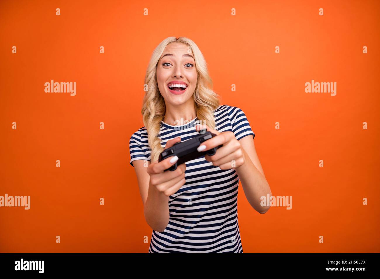 Portrait of attractive addicted cheerful girl playing game having fun ...