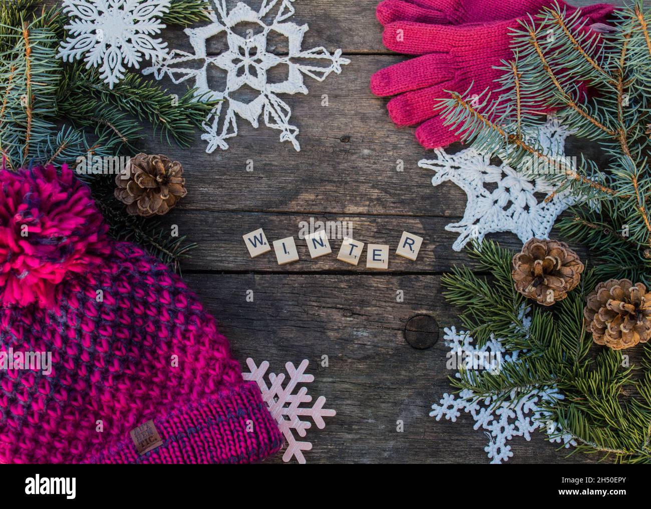 crochet snowflake ornaments on wooden ground with winter slogans and ...