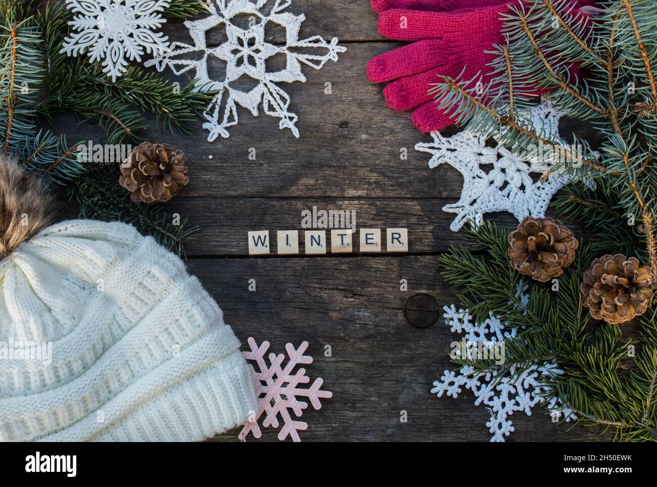 crochet snowflake ornaments on wooden ground with winter slogans and ...