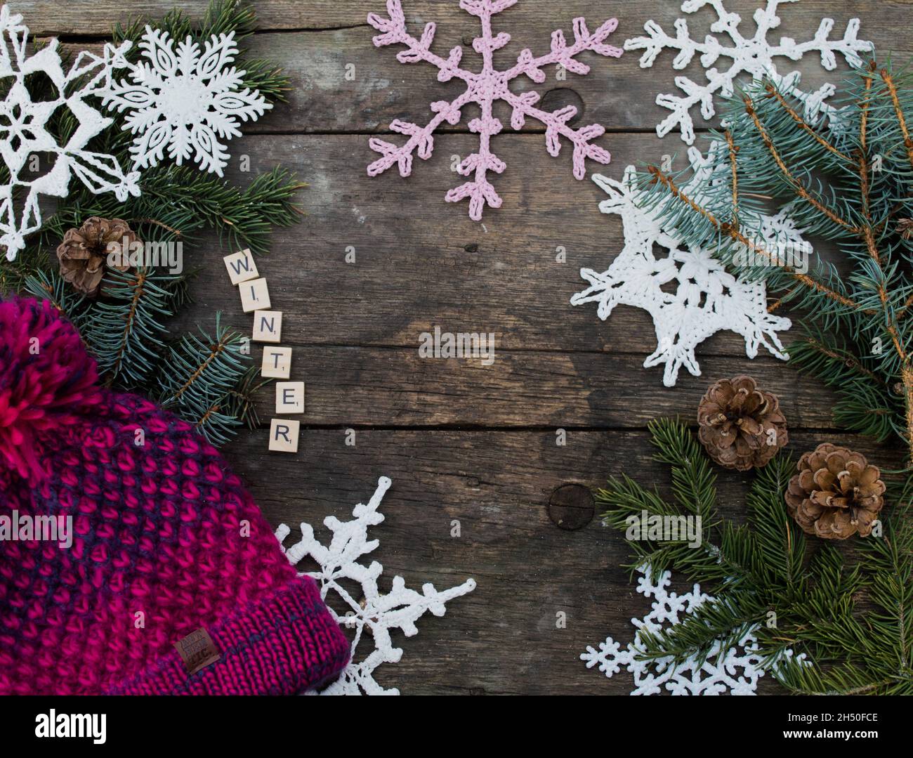 crochet snowflake ornaments on wooden ground with winter slogans and ...