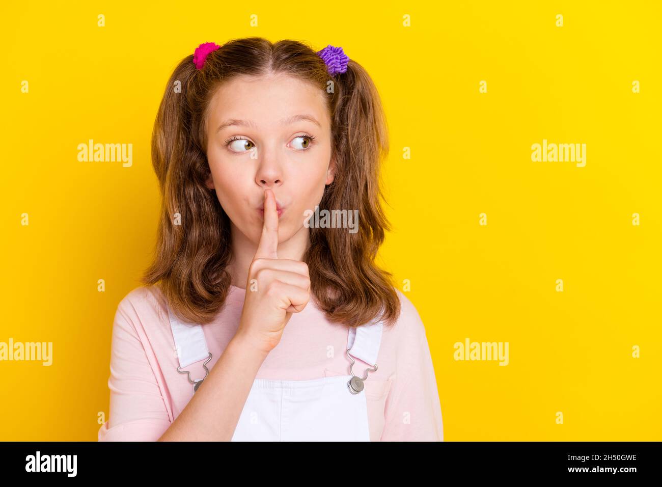 Portrait of attractive trendy brown-haired girl showing shh sign ...