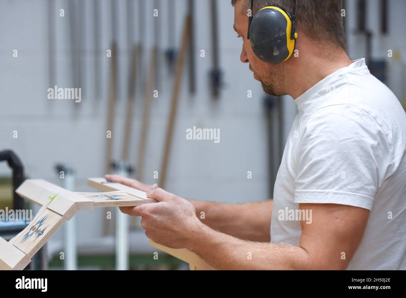 A man is making bespoke furniture in a woodwork workshop showing the ...
