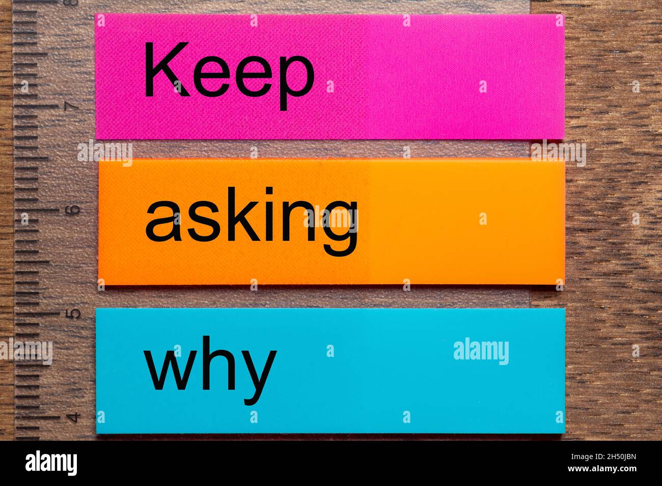 Three bookmark stickers with the words keep asking why, on a dark ...