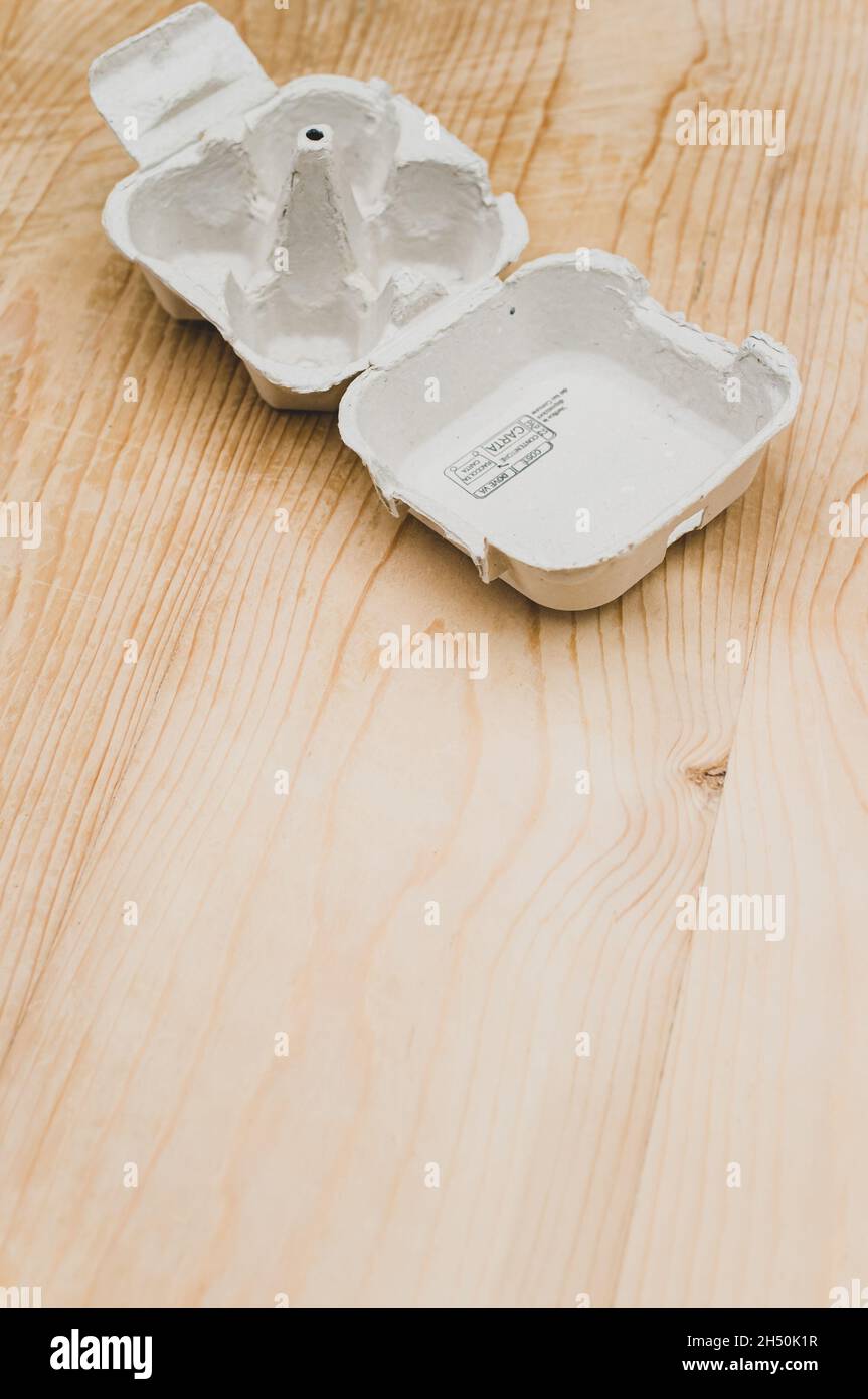 empty recycled cardboard egg box on a rustic wooden background with ...