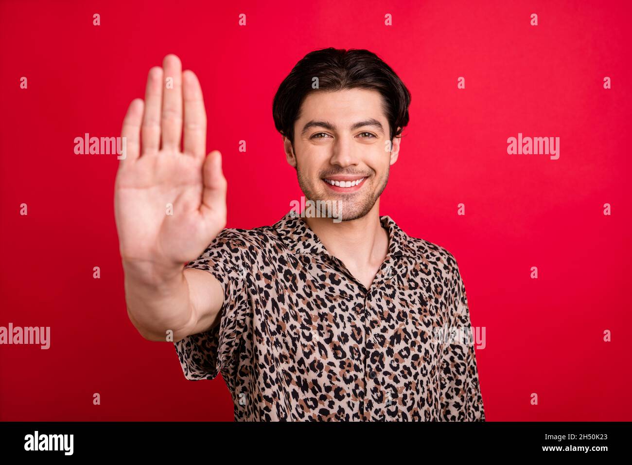 Photo of good mood smiling positive guy showing stop gesture ignore you ...