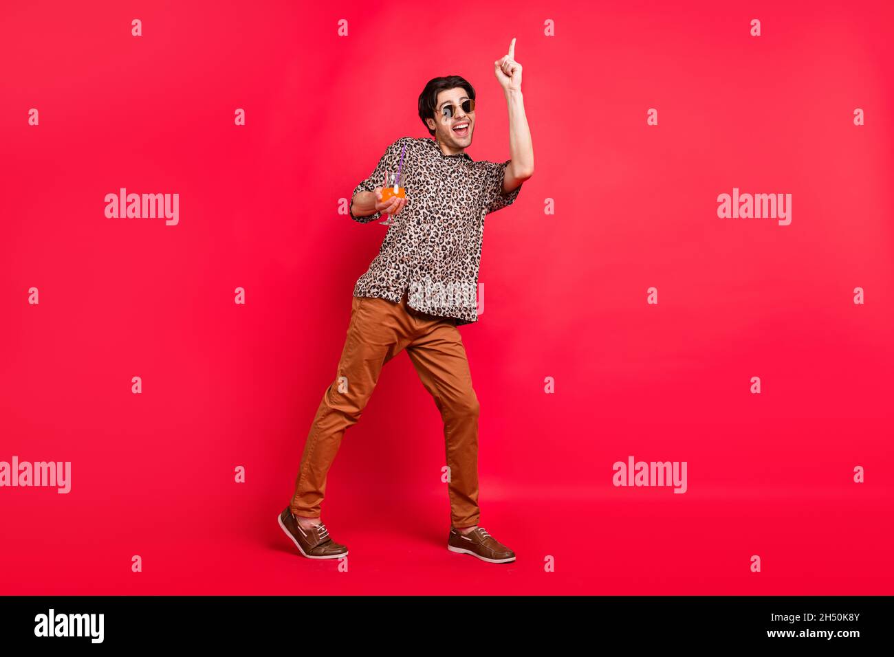 Full size photo of smiling excited cheerful man dancing point finger ...