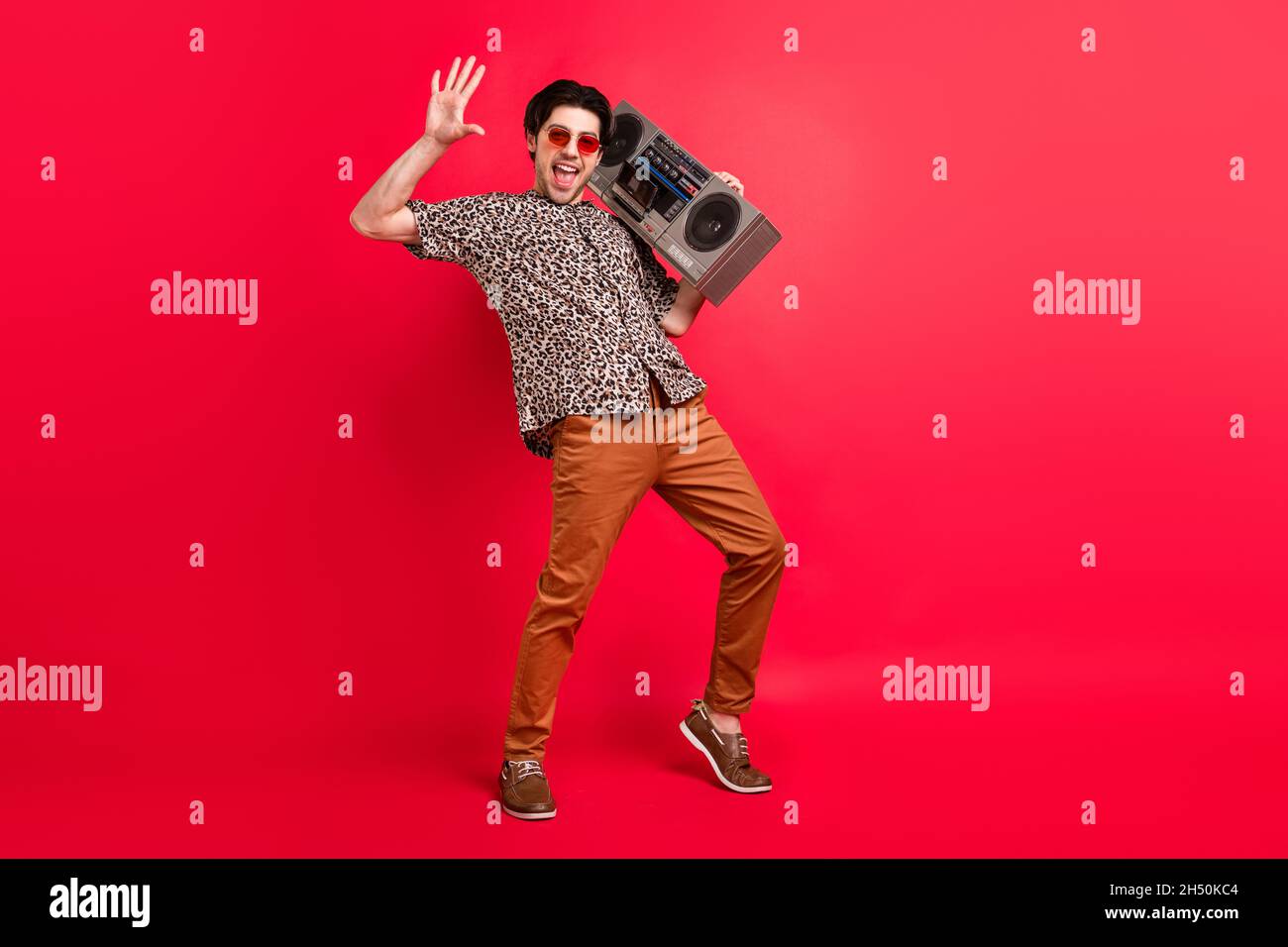 Full size photo of funky careless smiling guy dancing overjoyed hold ...