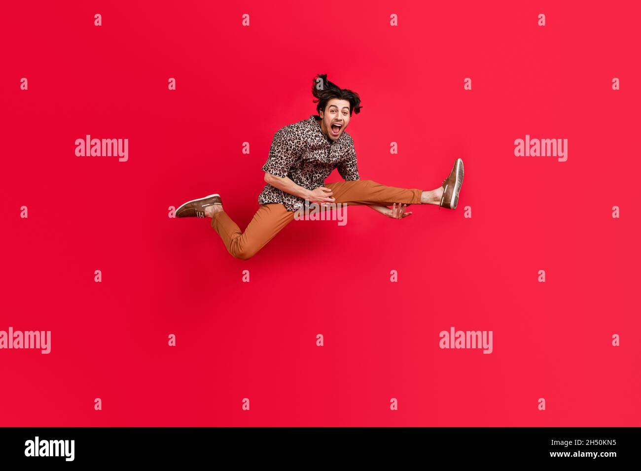 Full size photo of young crazy cheerful guy jumping playing guitar legs ...