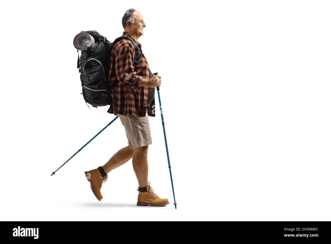 Full length profile shot of a mature hiker with a backpack walking with ...
