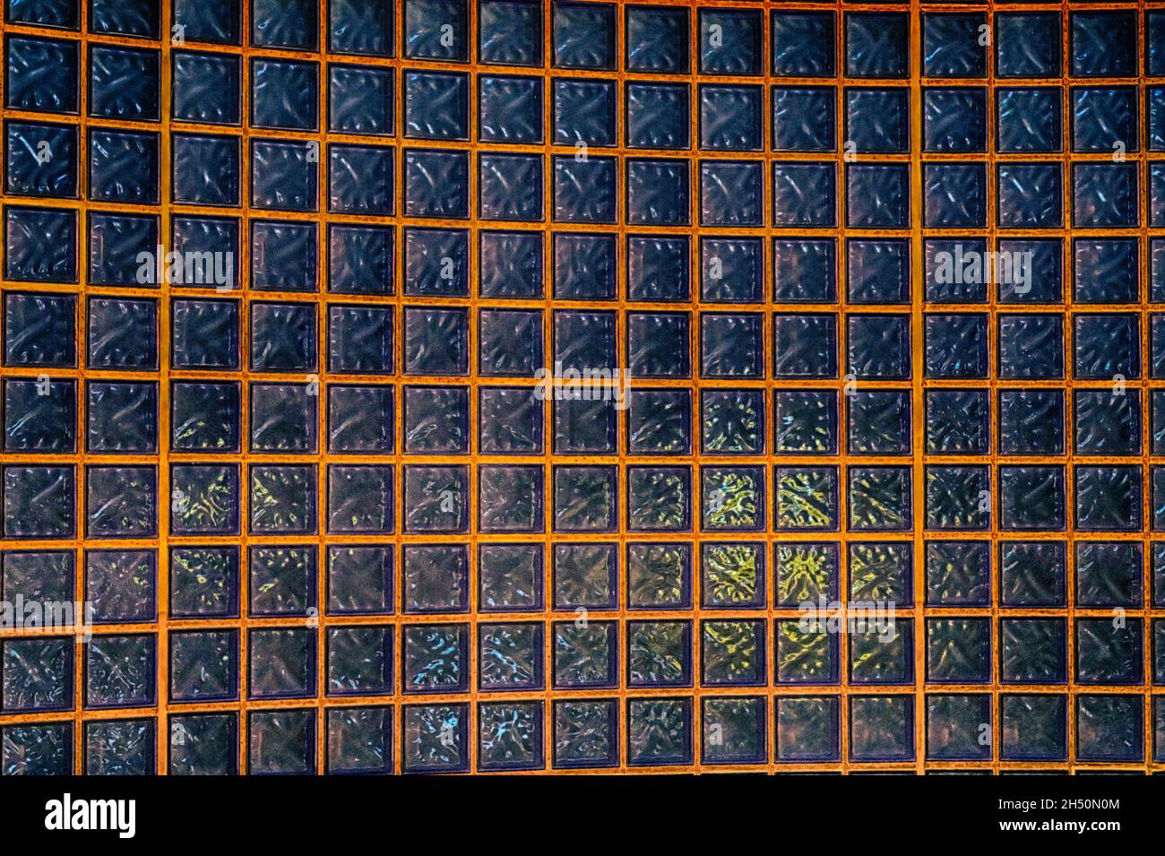 A wall of glass blocks which is lit from behind Stock Photo - Alamy