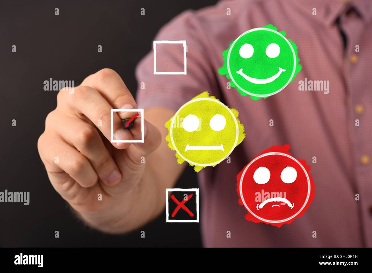 Man hand putting mark on happy angry and straight face on black ...