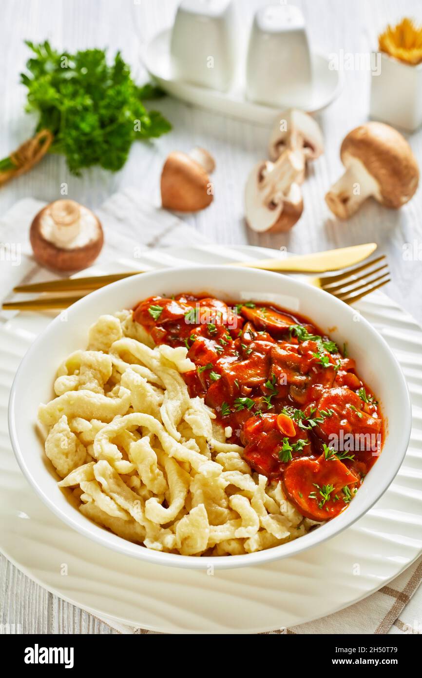 spaetzle with mushroom gravy in a white bowl, jagerspatzle ...