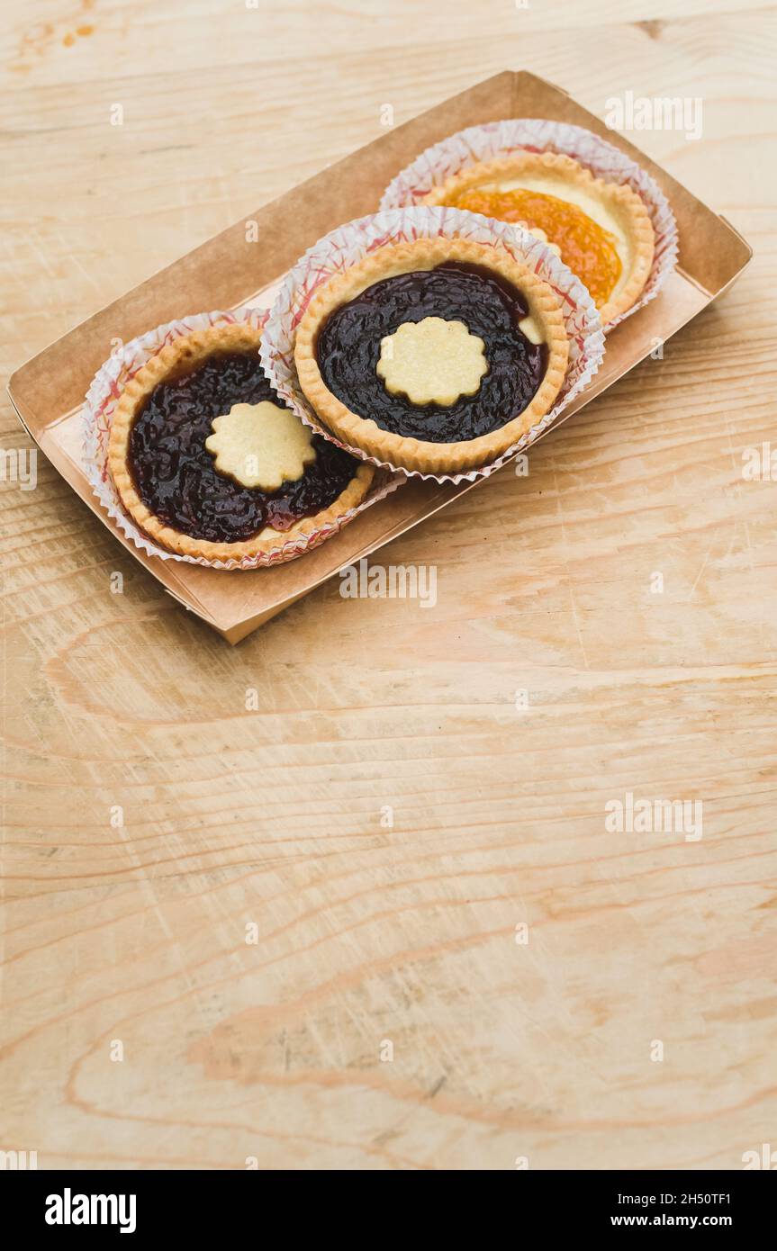 peach and cherry jam short crust pastry in a paper backing cup on a ...