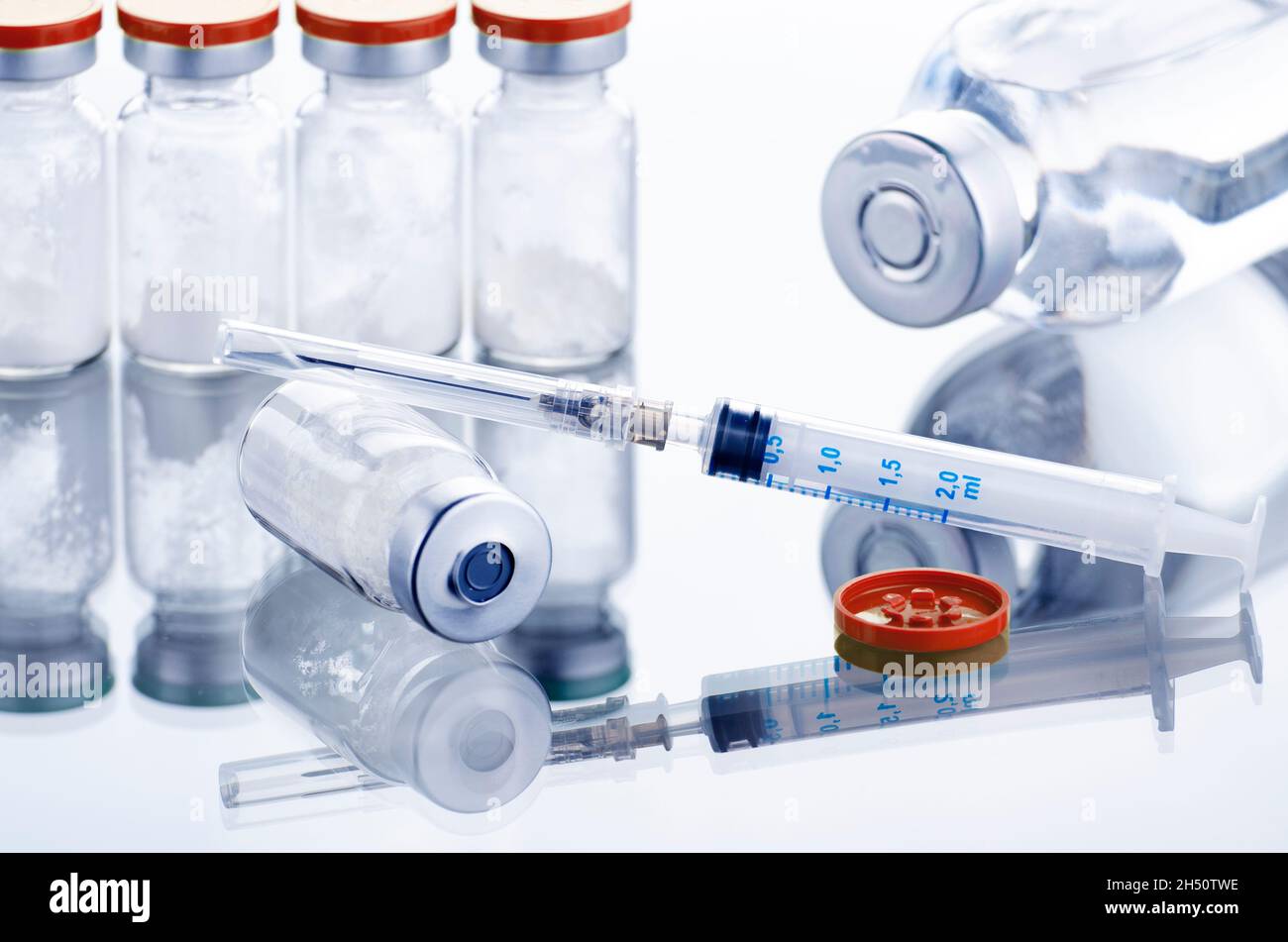 Powdered drug in vial as vaccine dose flu shot along with syringe for ...