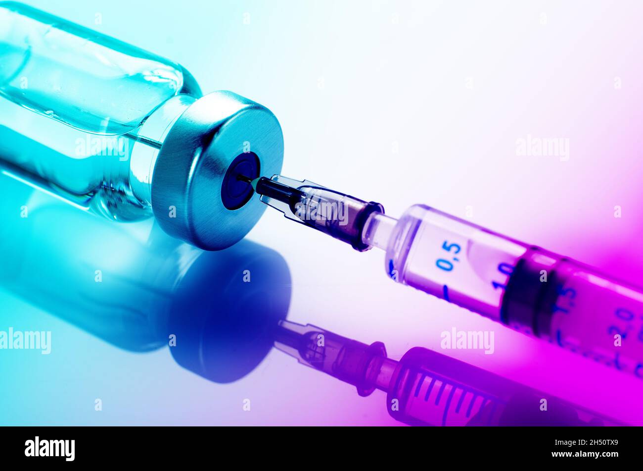 Just opened vaccine vial with inserted syringe for injection treatment ...