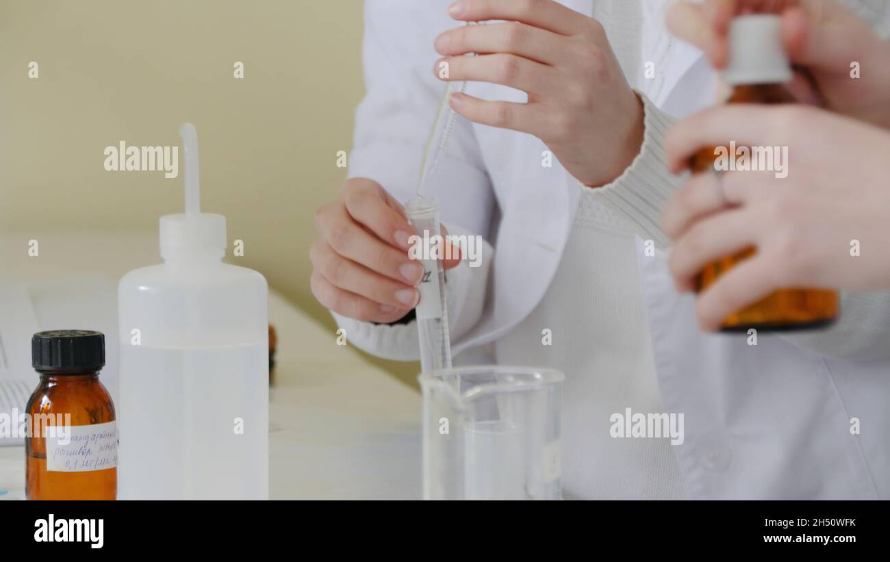 Medical worker with dropper testing fluids. Student used laboratory ...