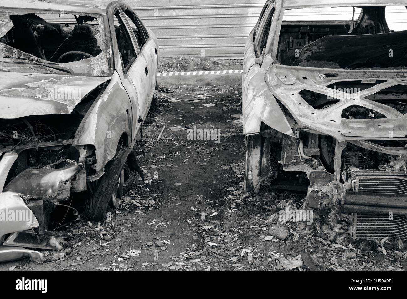 Skeletons of two burnt out cars after fire Stock Photo - Alamy