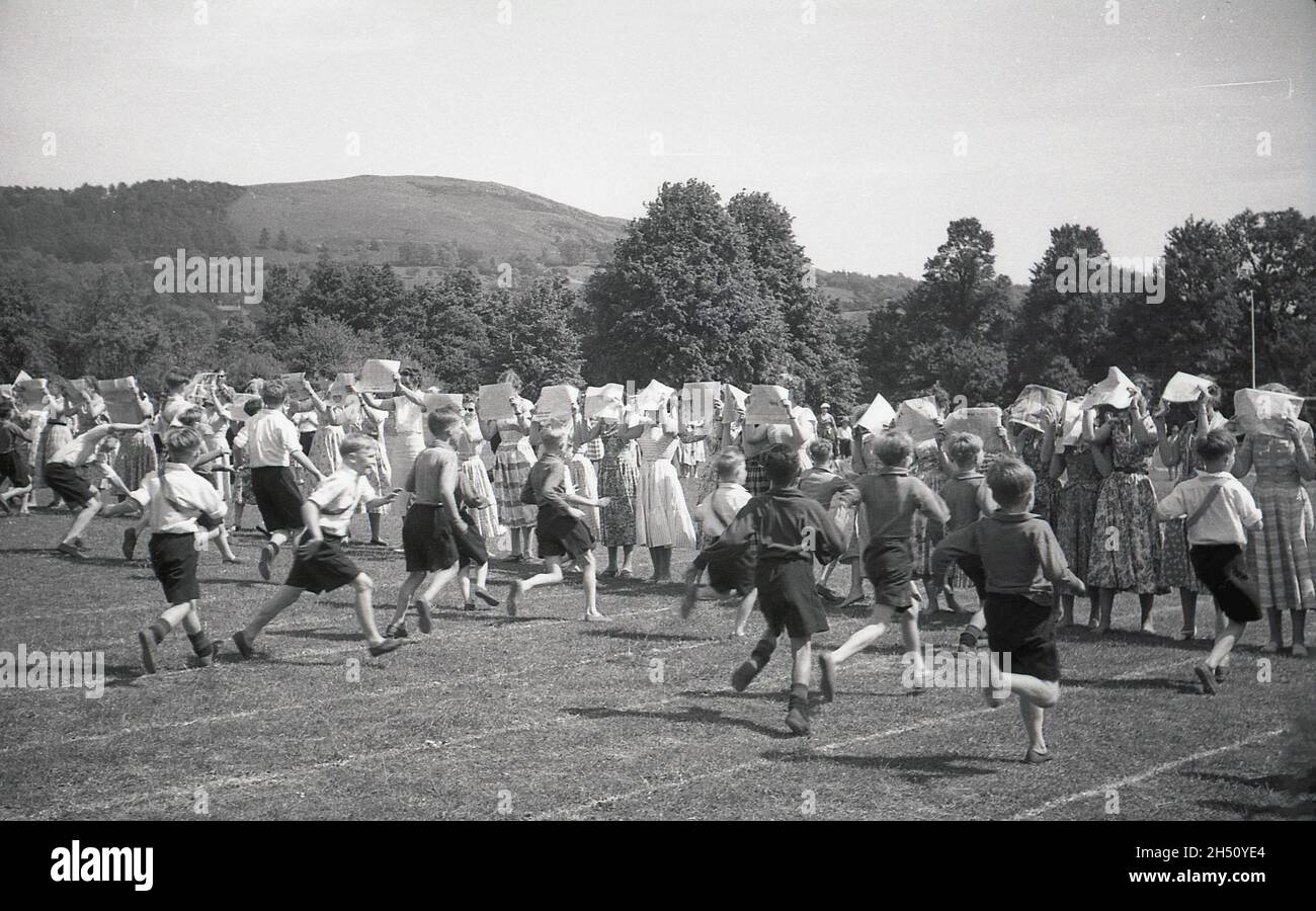 1950s, historical, at a junior school sports day, outside in a playing ...