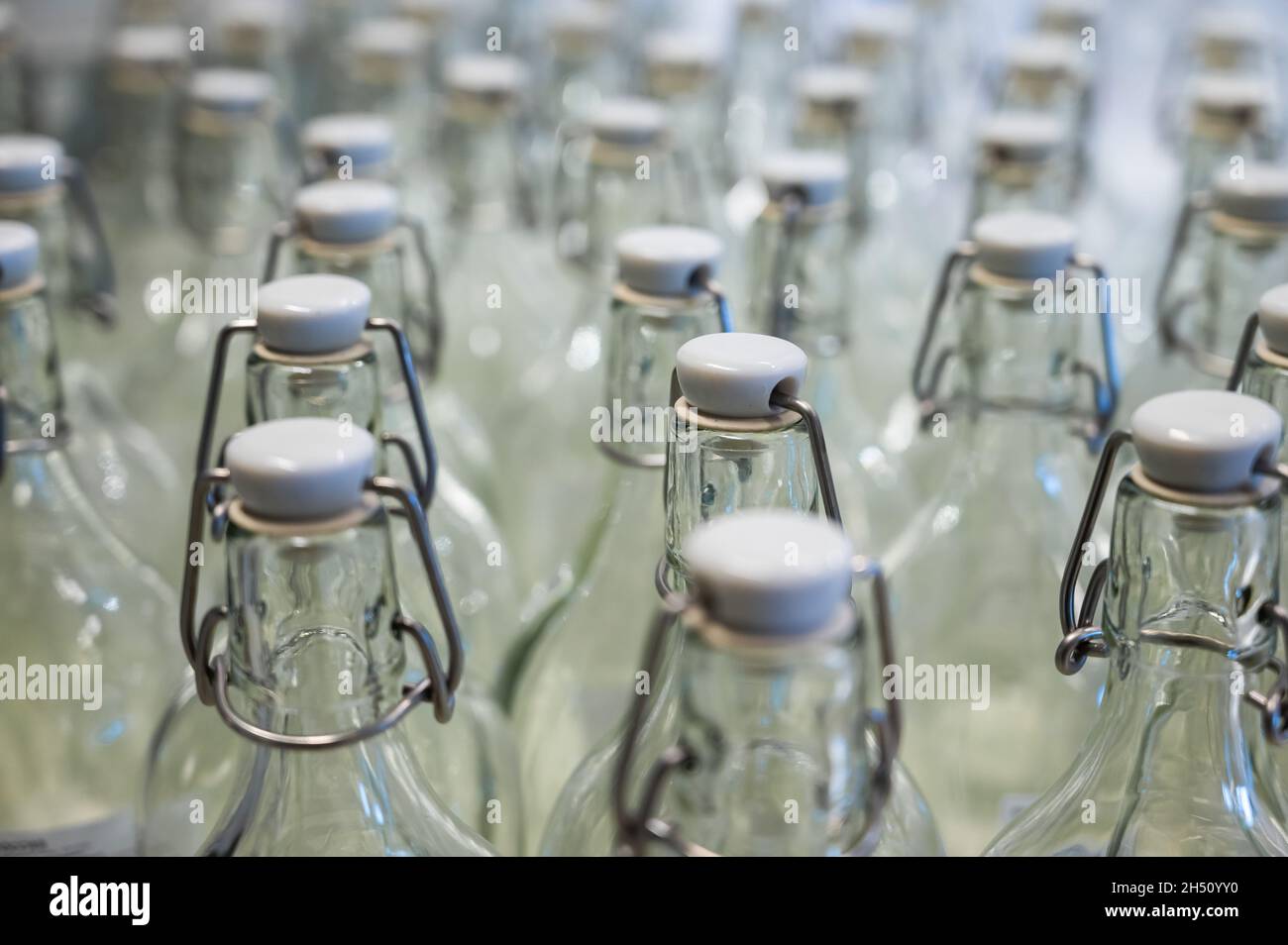 A closeup of the neck of a bottle. Group of empty bottles with plastic ...