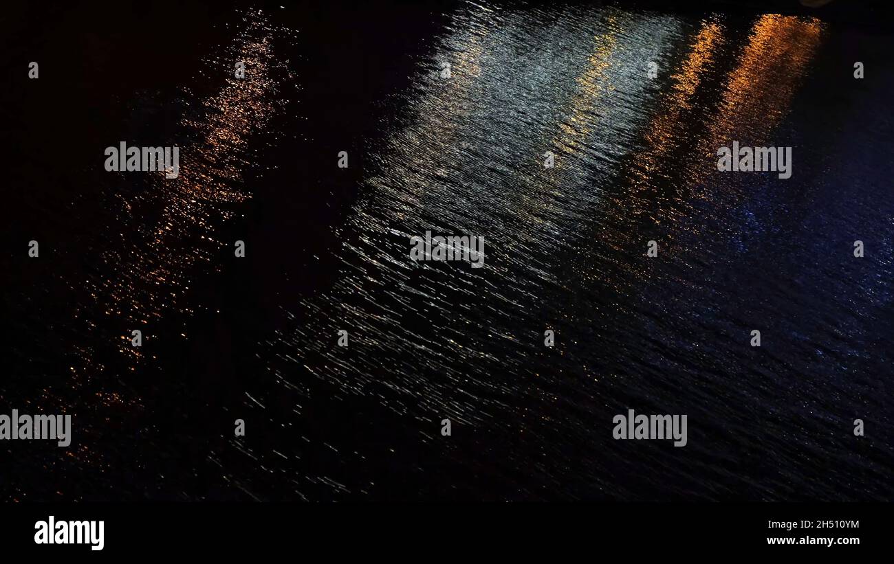 Close-up of pond dark water surface during the night with reflection ...