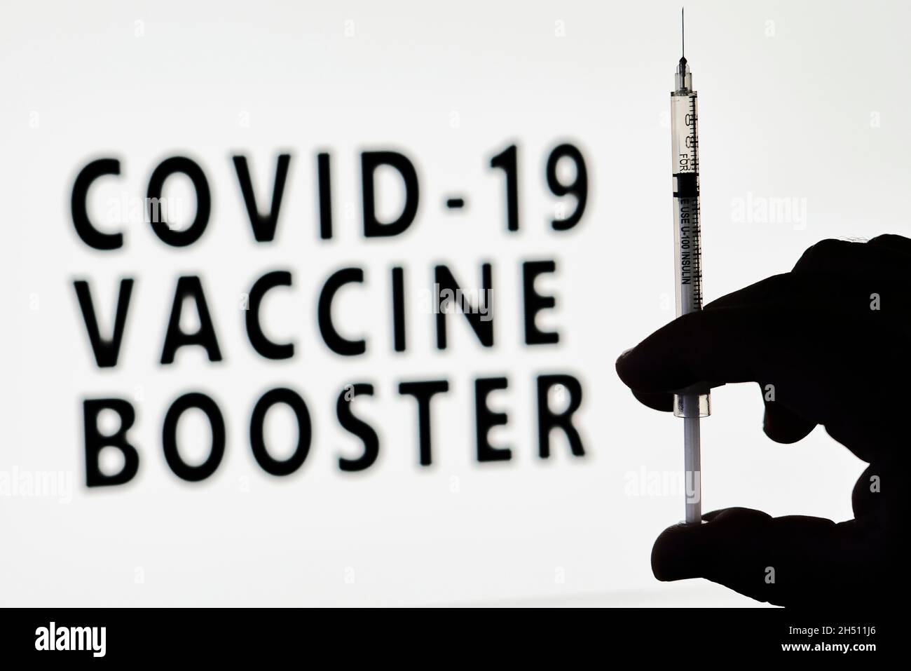 Covid-19 Vaccine booster dose. Hand of the doctor holds a syringe with ...