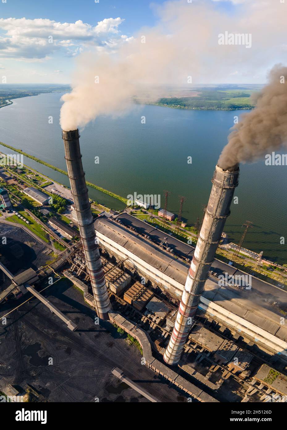 Aerial view of coal power plant high pipes with black smokestack ...