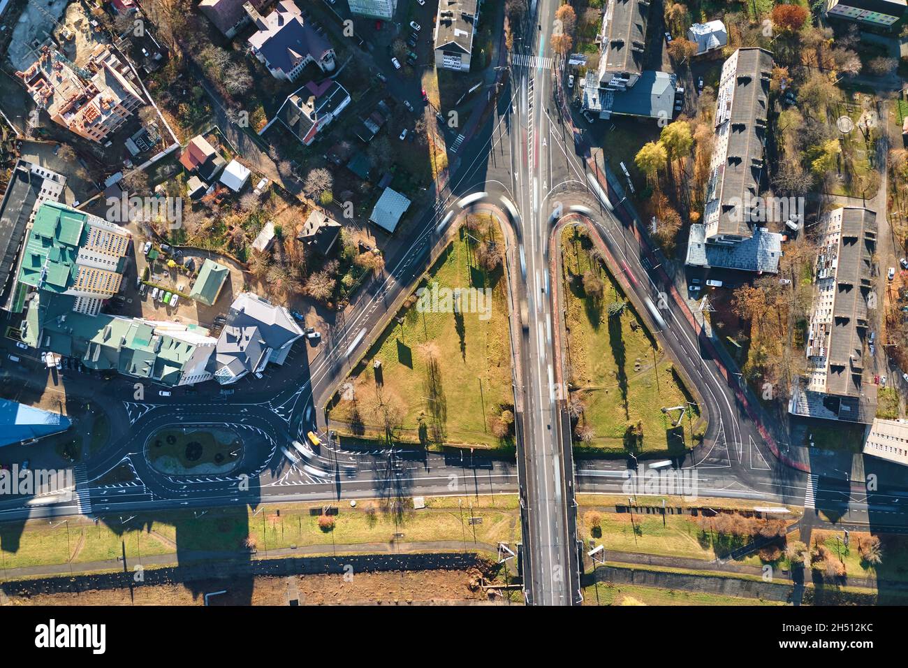 Aerial view of road intersection with fast moving heavy traffic on city ...