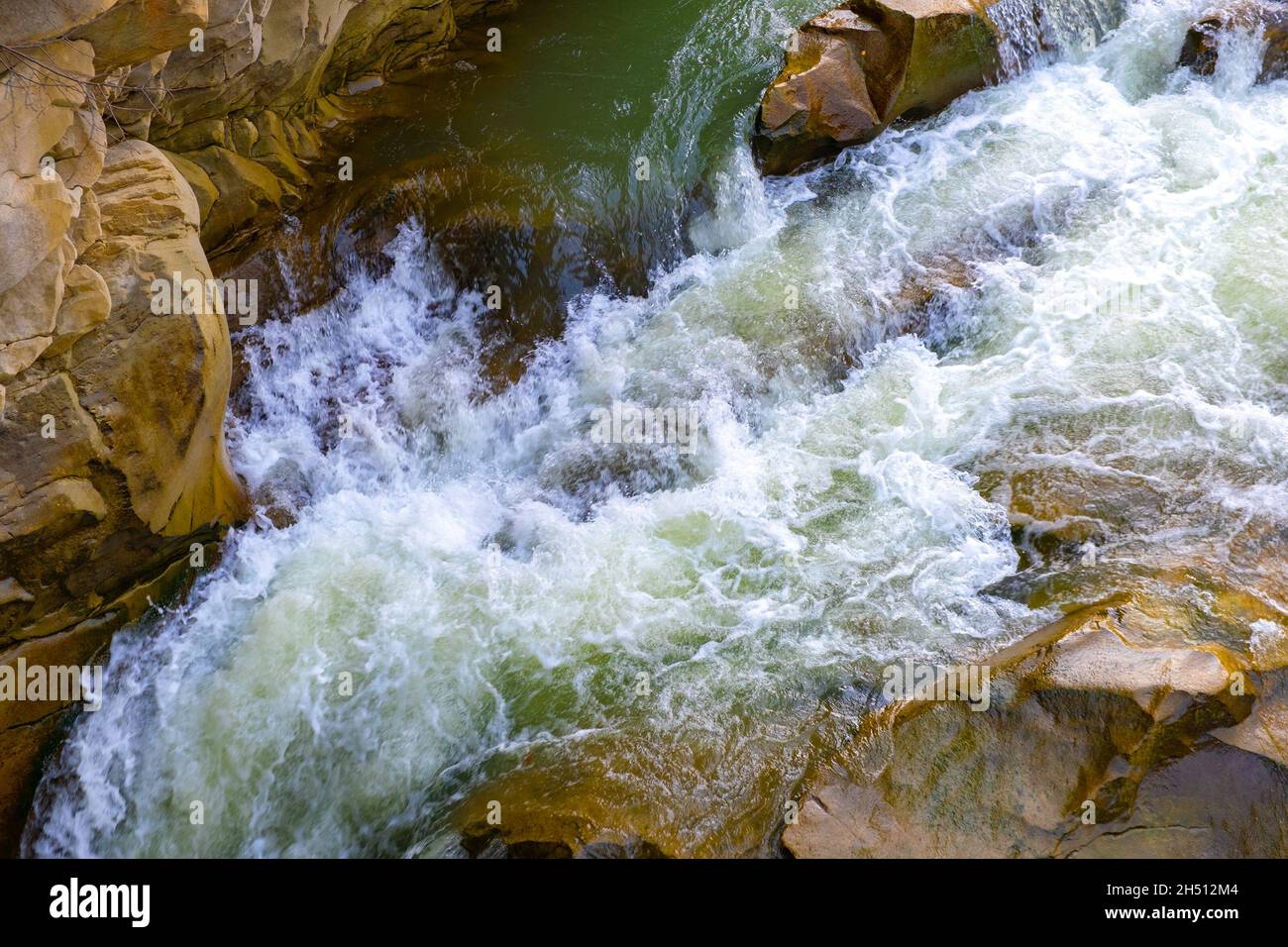 Aerial view of river waterfall with clear turquoise water falling down ...