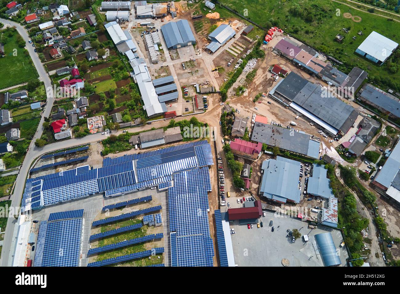 Aerial view of solar power plant with blue photovoltaic panels mounted ...