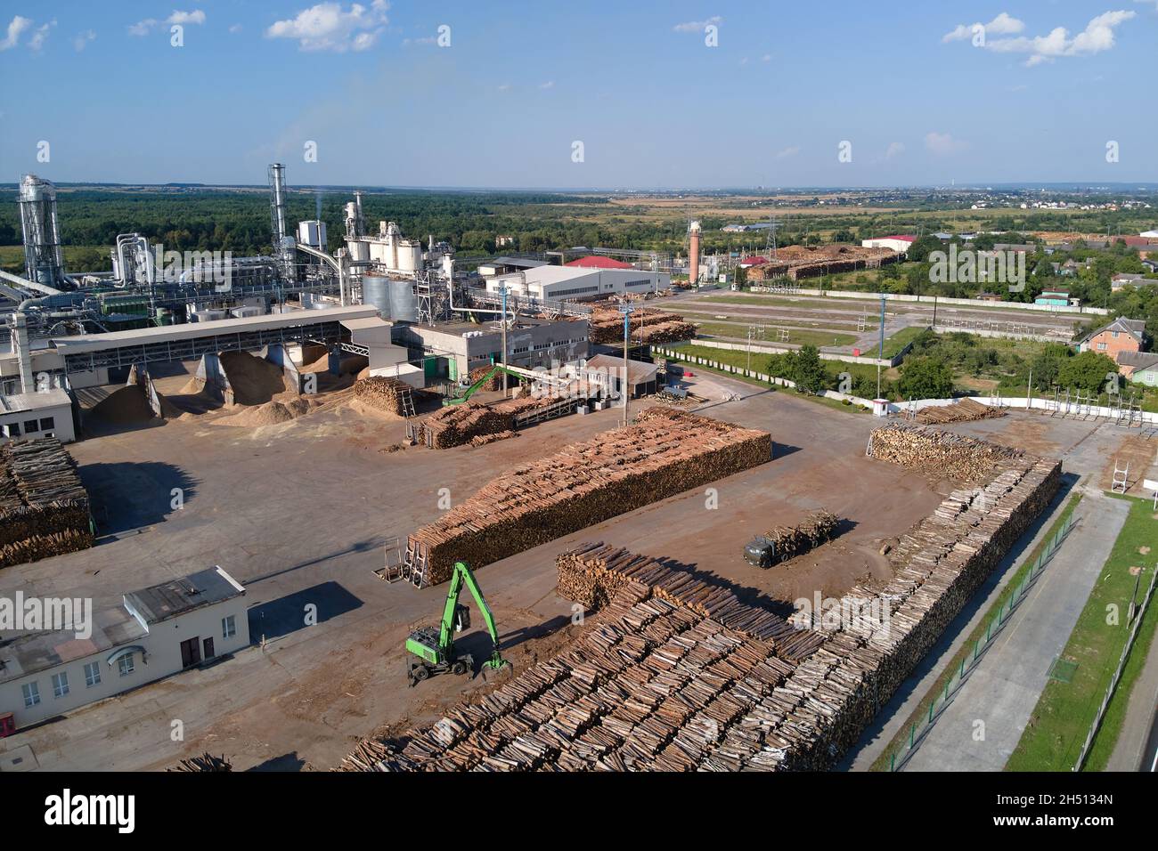 Aerial view of wood processing factory with stacks of lumber at plant ...