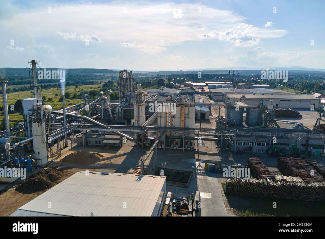 Aerial view of wood processing factory with stacks of lumber at plant ...