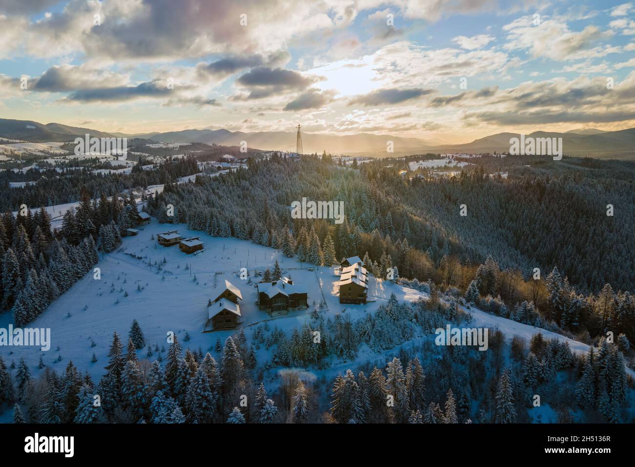 Aerial winter landscape with small village houses between snow covered ...