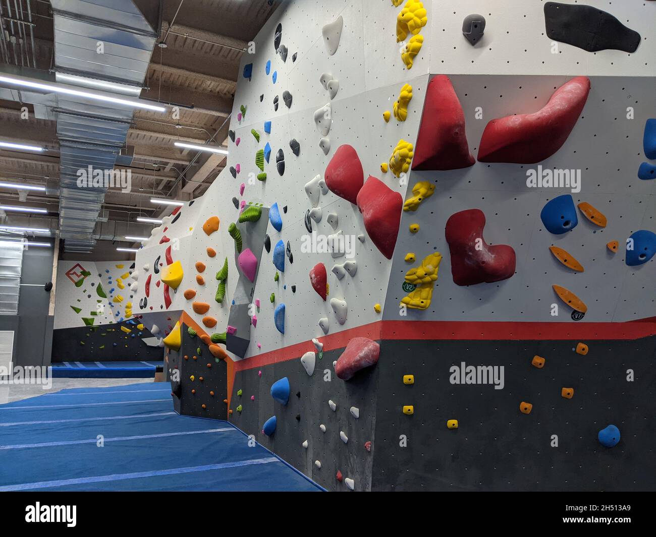 Indoor bouldering and climbing wall for training at a modern gym Stock ...