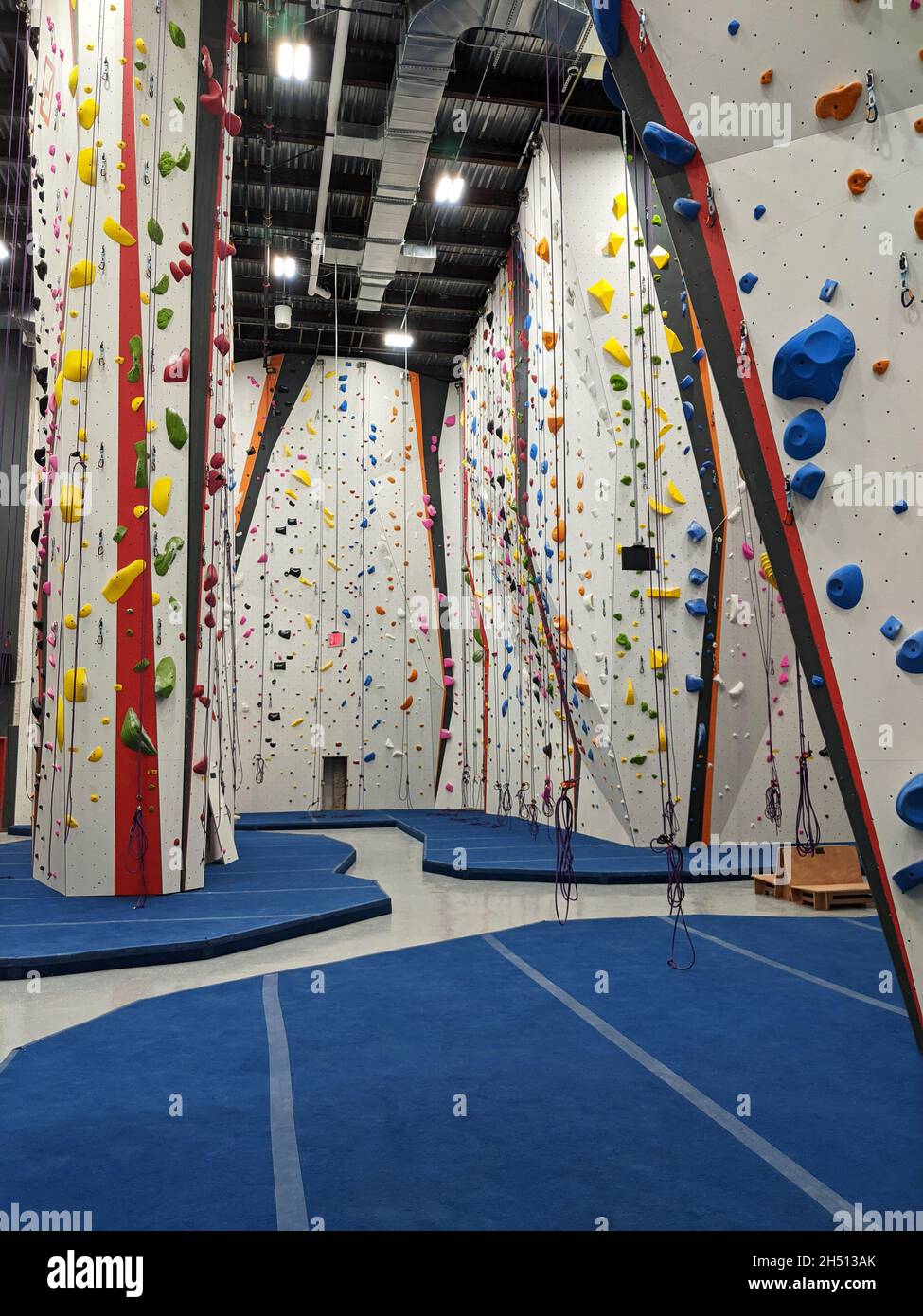 Indoor bouldering and climbing wall for training at a modern gym Stock ...