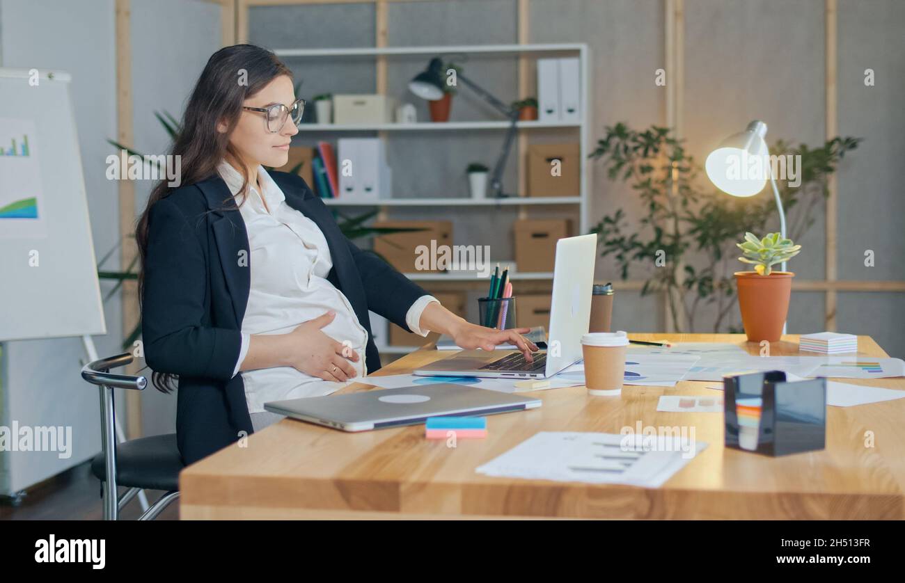 Beautiful Young Pregnant Woman at Work in a Comfortable Modern Office ...