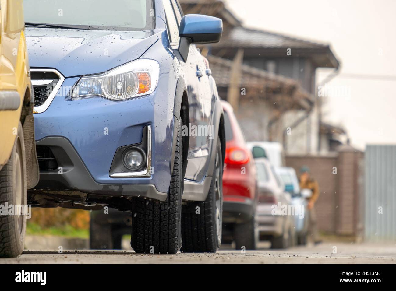 Cars parked in a row on a city street side Stock Photo - Alamy