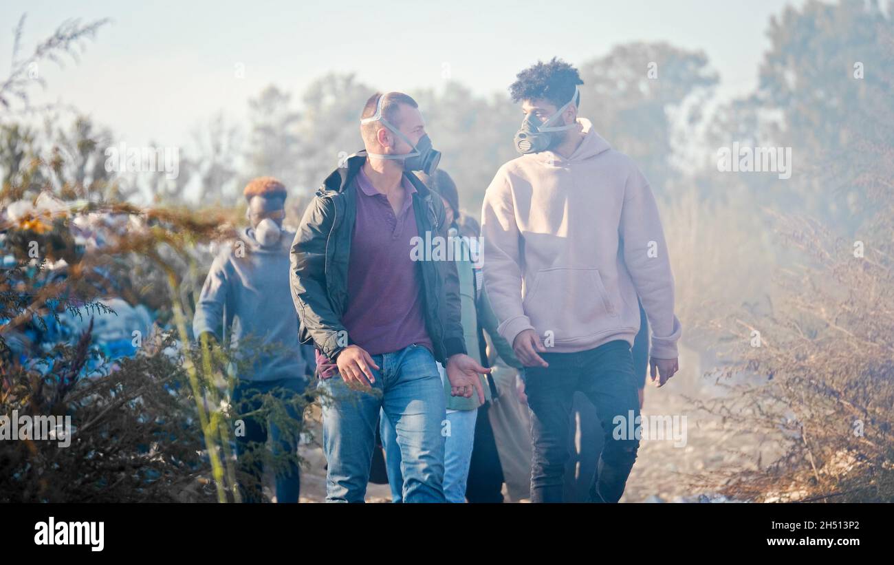 Group of Young People in Gas Masks Going Through the Toxic Smoke in a ...