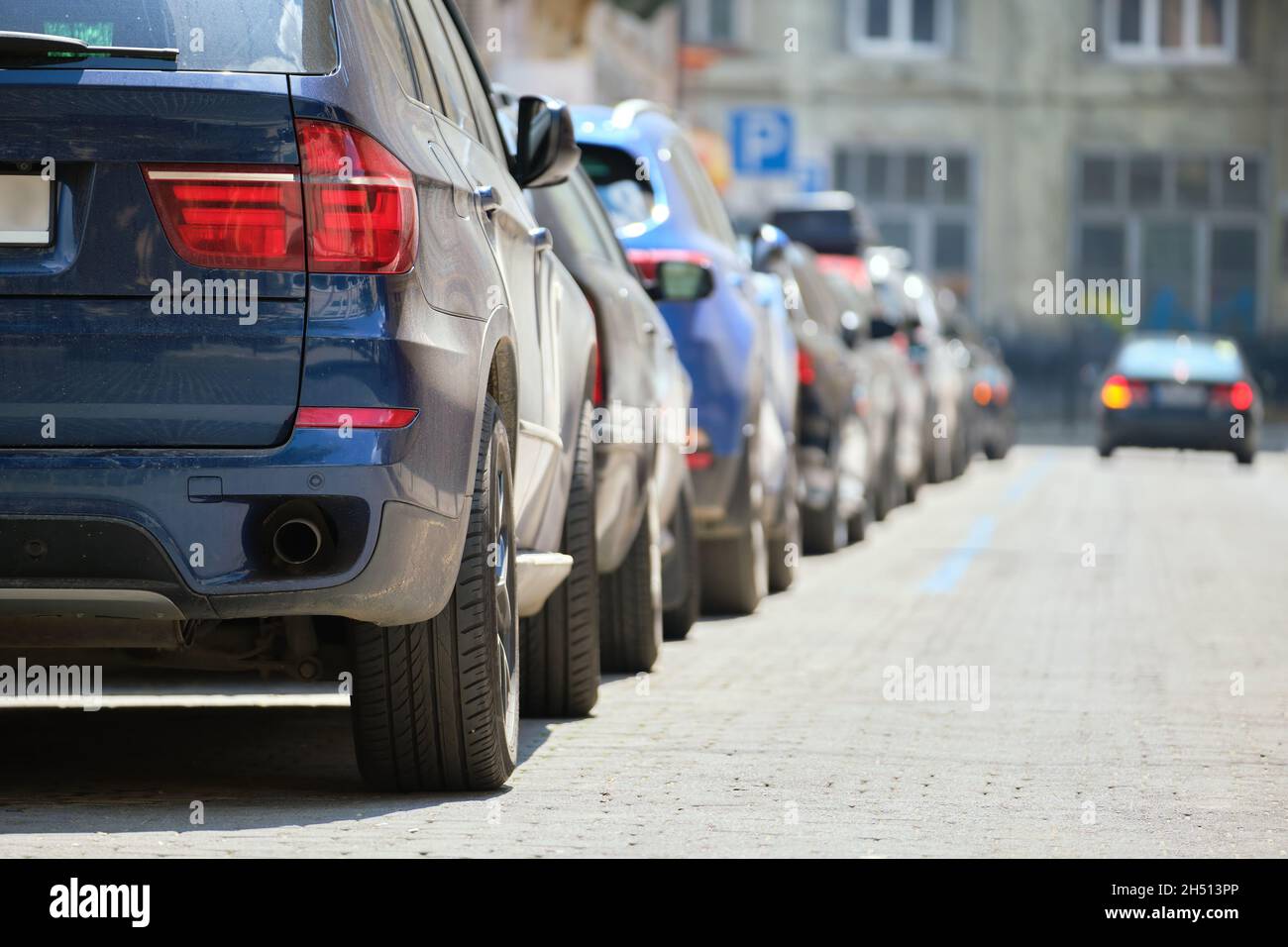 City traffic with cars parked in line on street side Stock Photo - Alamy